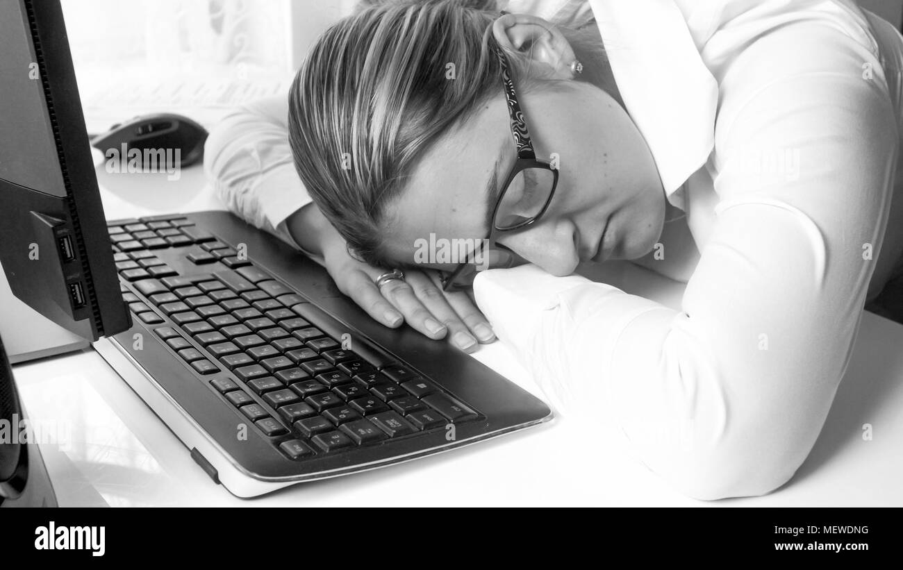 Black and white portrait of tired business woman worker sleeping on ...