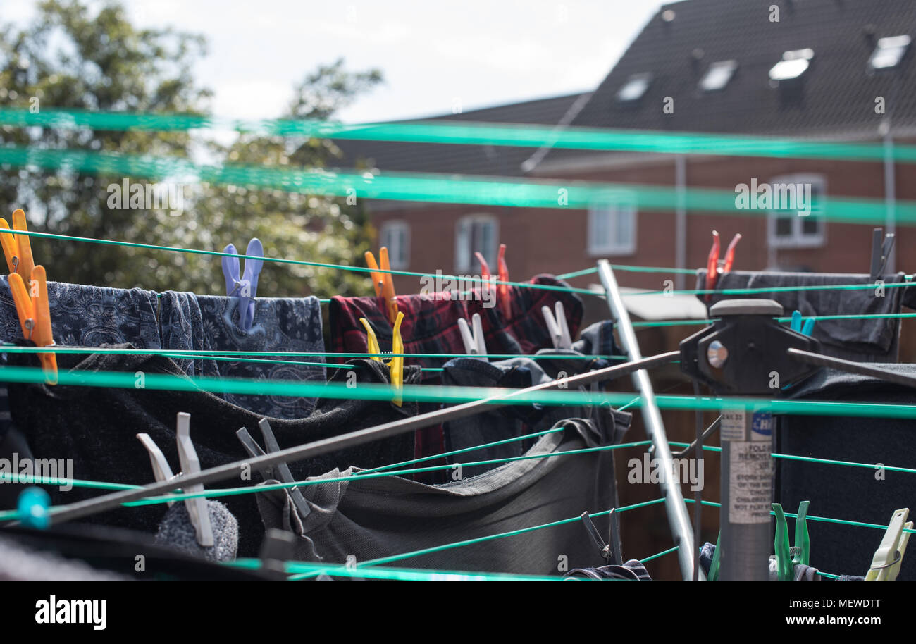 Laundry hanging on a garden washing line drying in the bright sunshine ...