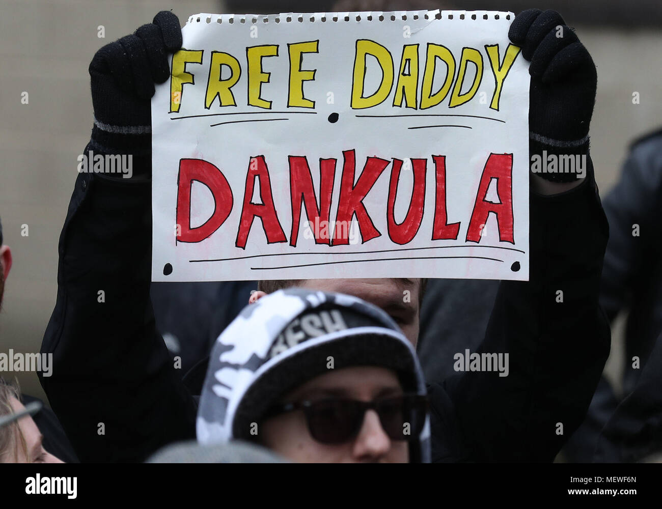 A supporter of Mark Meechan holds a poster referring to his YouTube ...