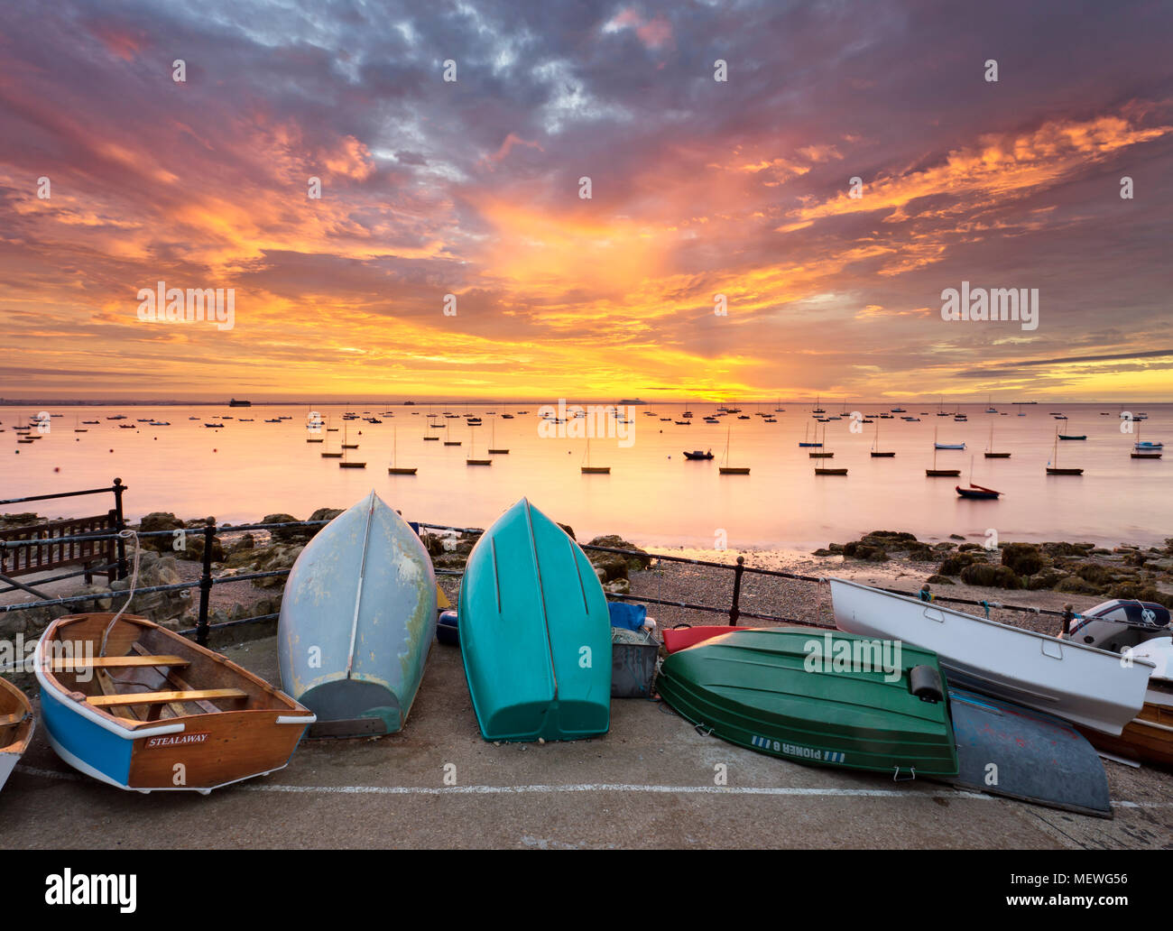 Seaview pink sunrise with boats at the shore Stock Photo - Alamy