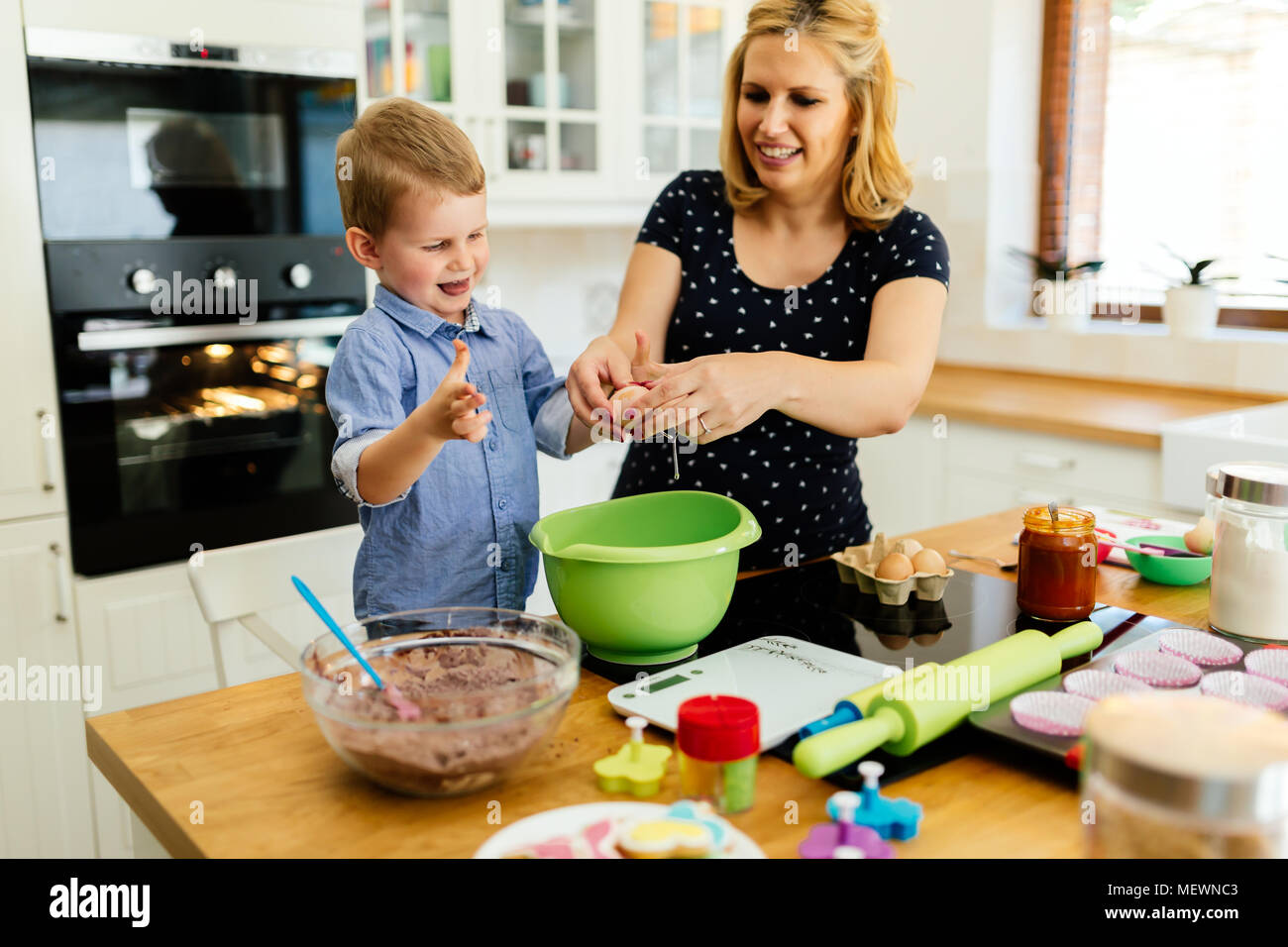 Child helping mother bake cookies Stock Photo - Alamy