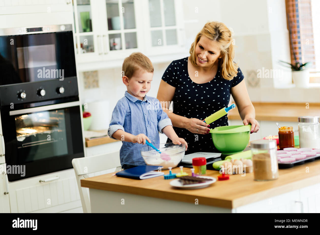 Child helping mother bake cookies Stock Photo - Alamy
