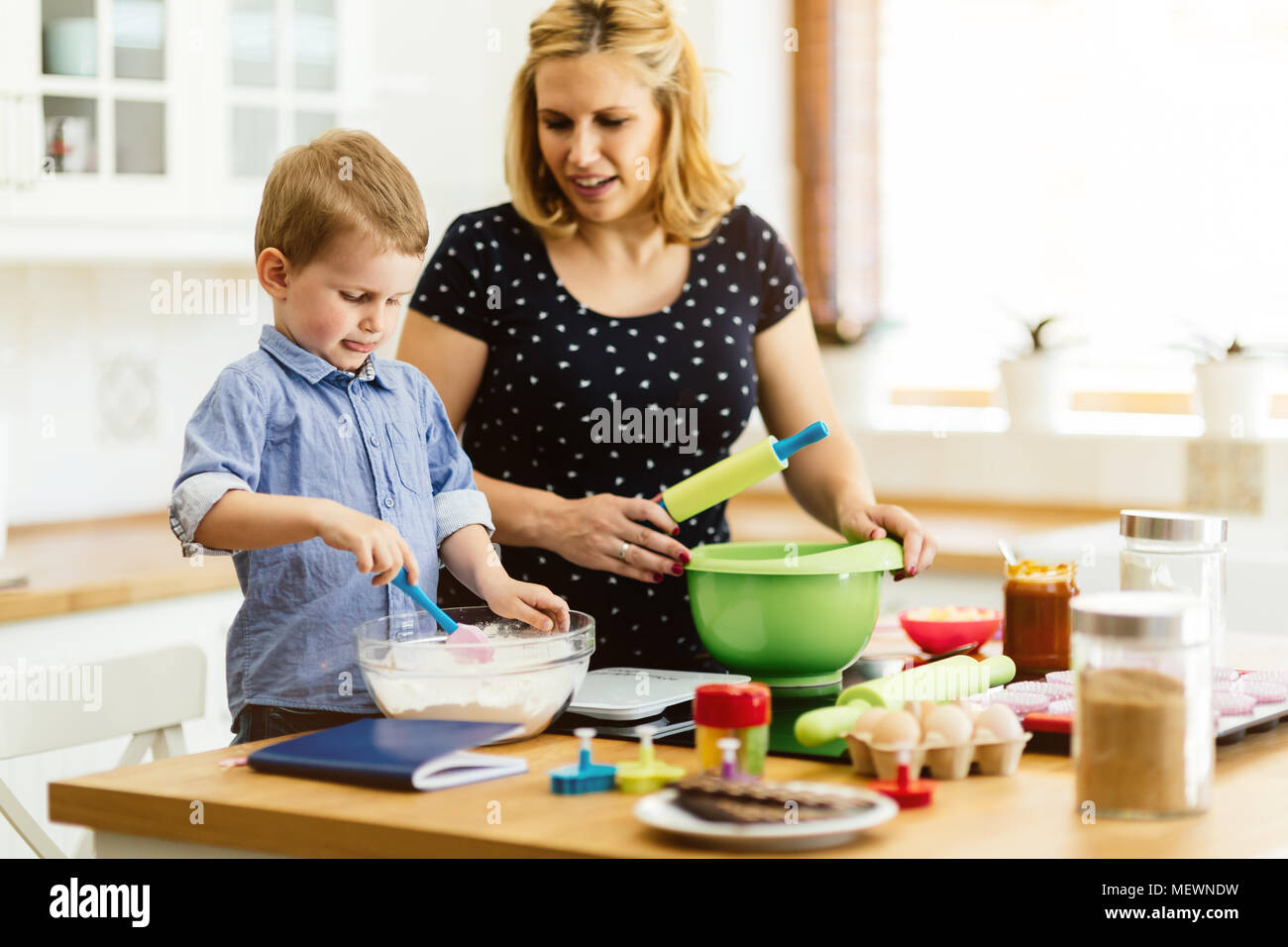 Child helping mother bake cookies Stock Photo - Alamy