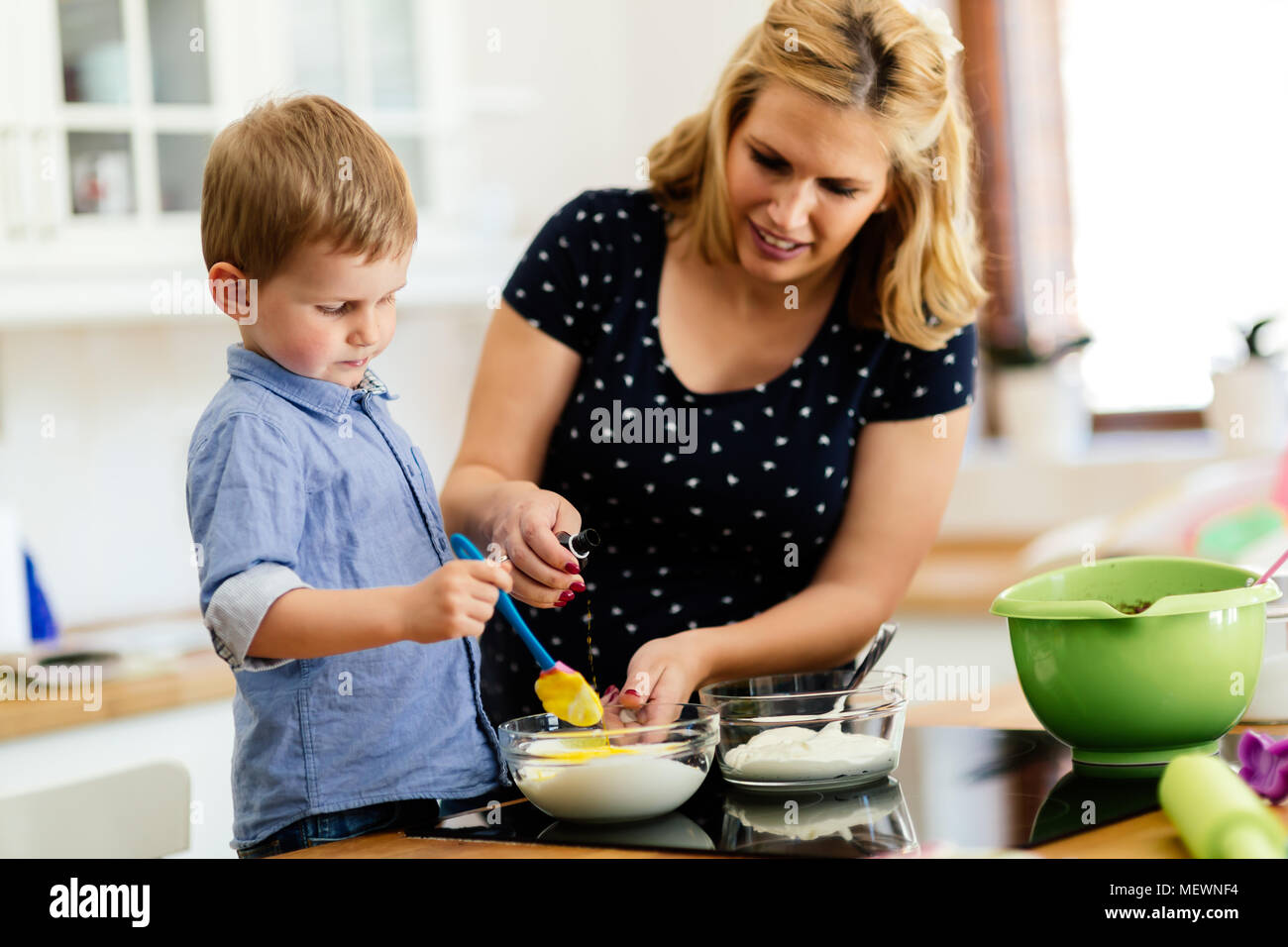 Child helping mother bake cookies Stock Photo - Alamy