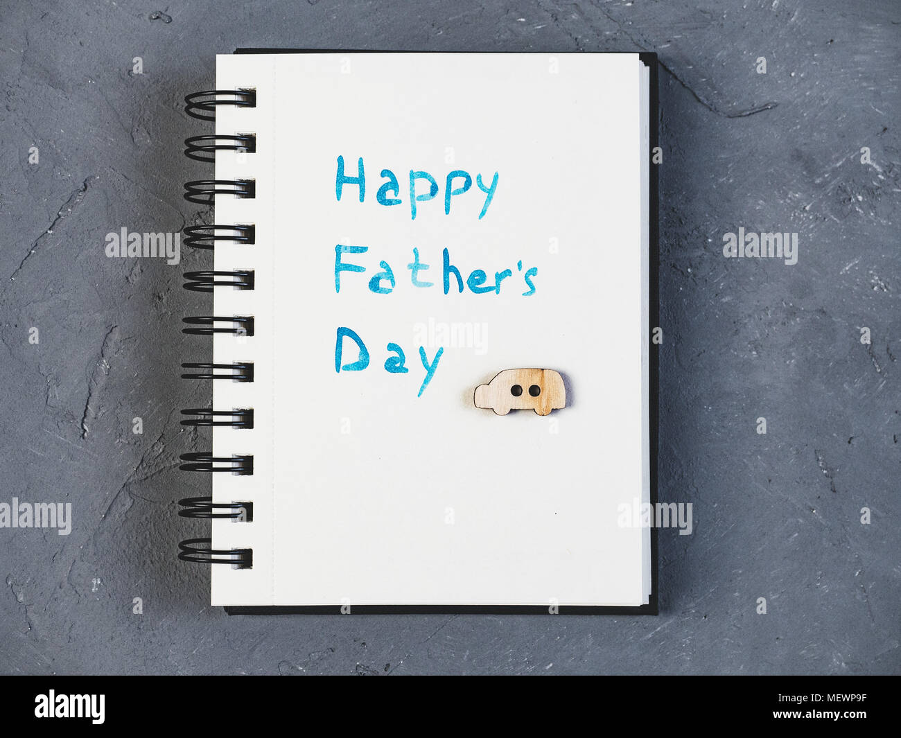 Notepad with handwritten greeting on Father's day on a beautiful, grey ...