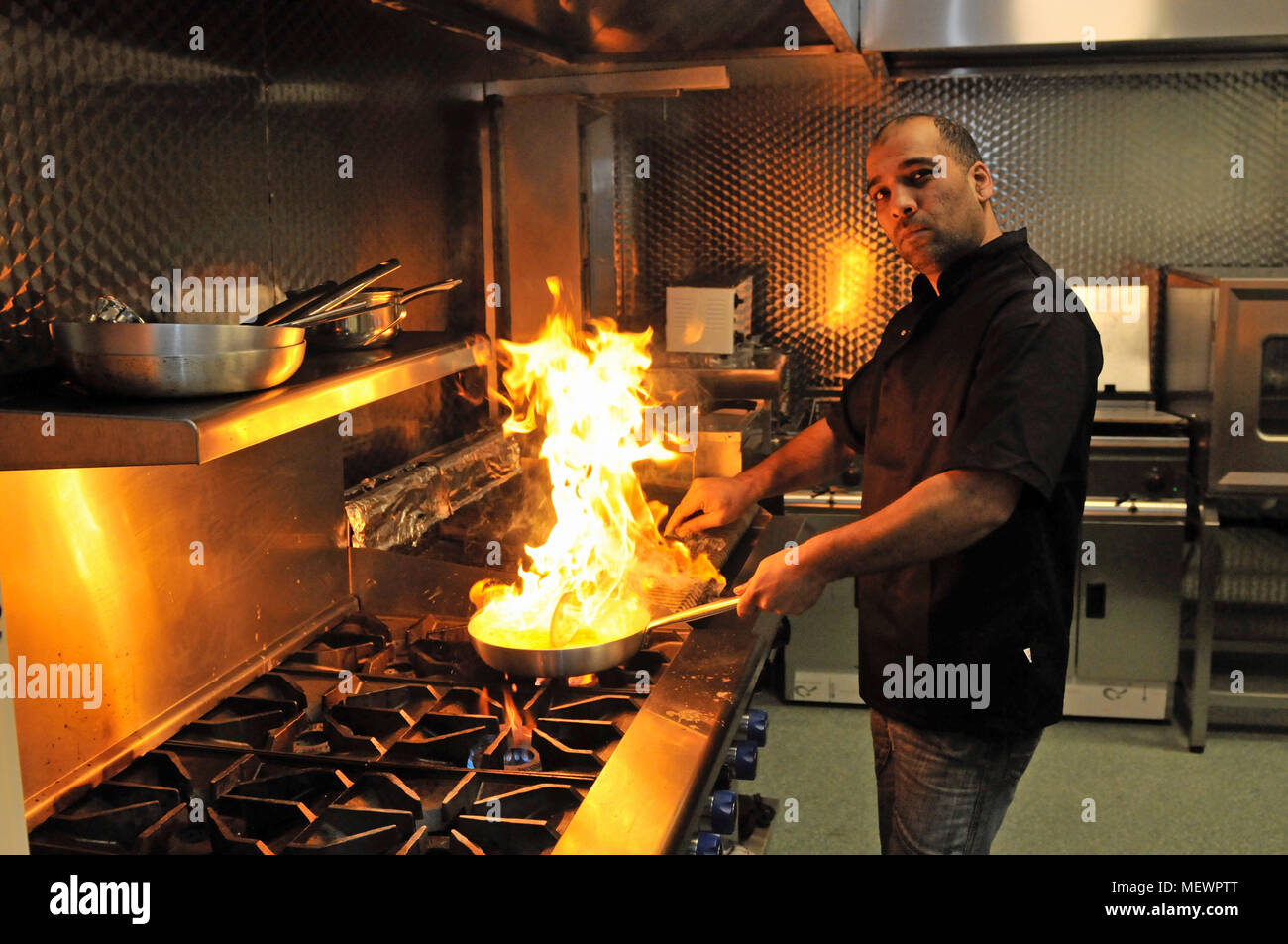 Chef cooking on stove making flames while cooking Stock Photo - Alamy