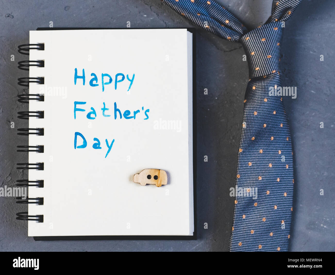 Silk bow tie and notepad with handwritten greeting on Father's day on a ...
