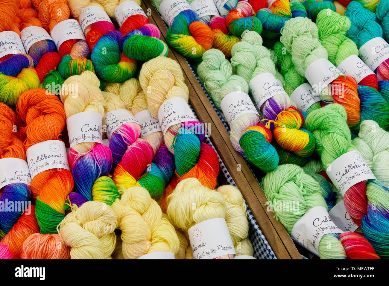 Multi-coloured skeins of wool on a retailers stall at Yarndale, Skipton ...