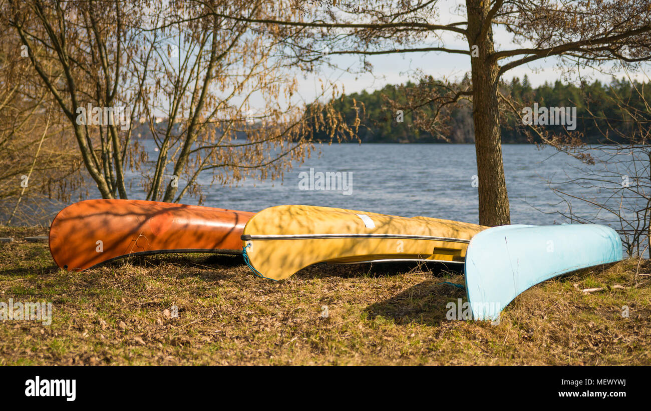 Amazing light color of three canoe during golden hour on the shore of ...
