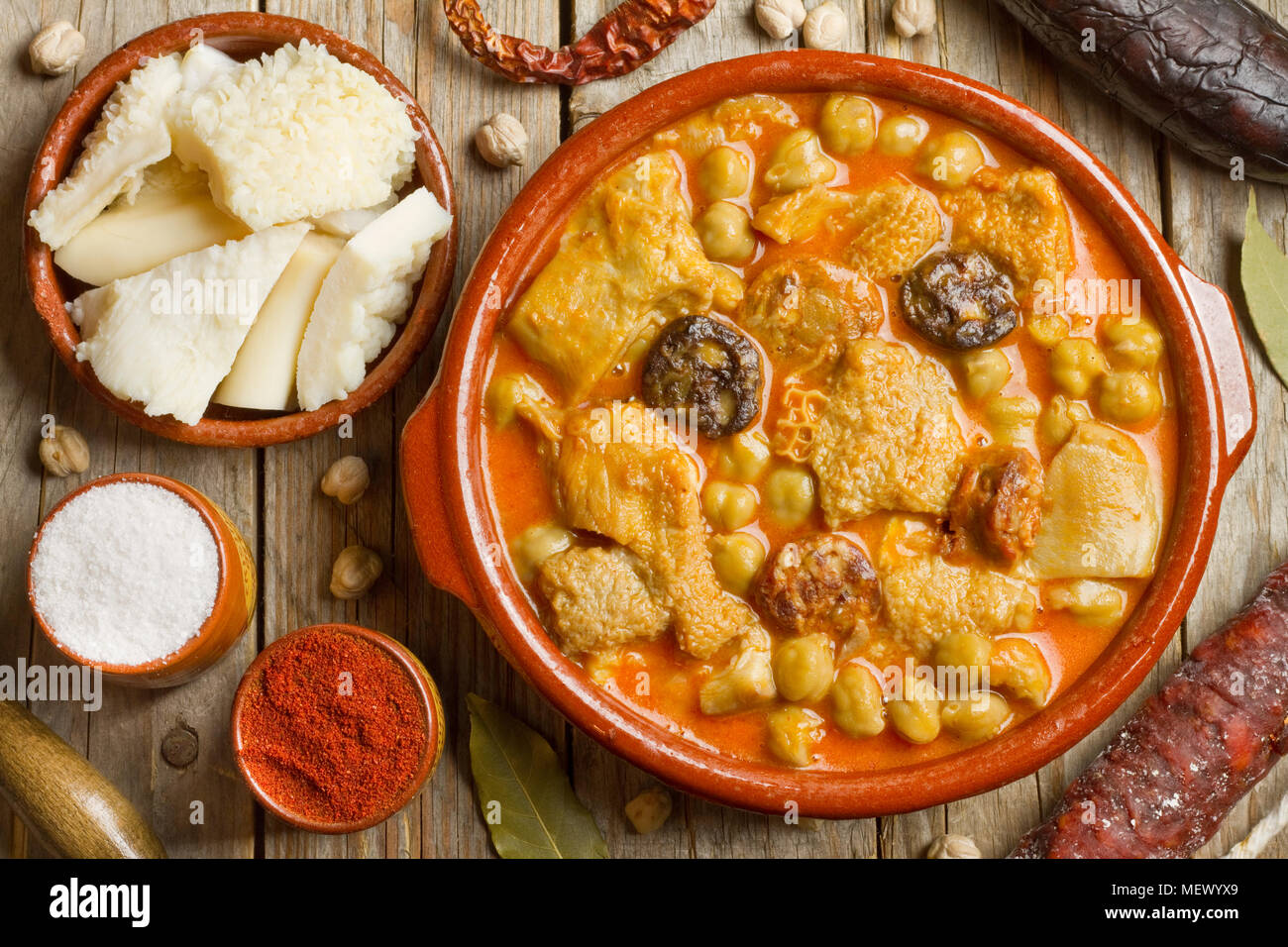 Spanish callos with chickpeas and ingredients on a wooden table Stock ...