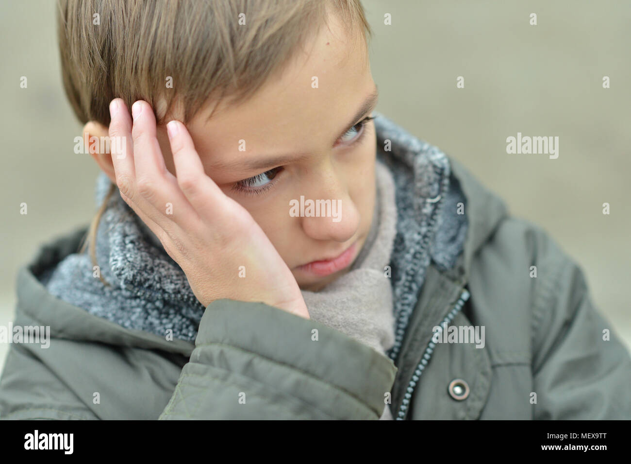Portrait of a sad boy outdoors Stock Photo - Alamy
