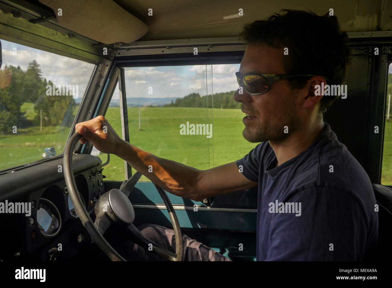 caucasian man driving a off road jeep Stock Photo - Alamy