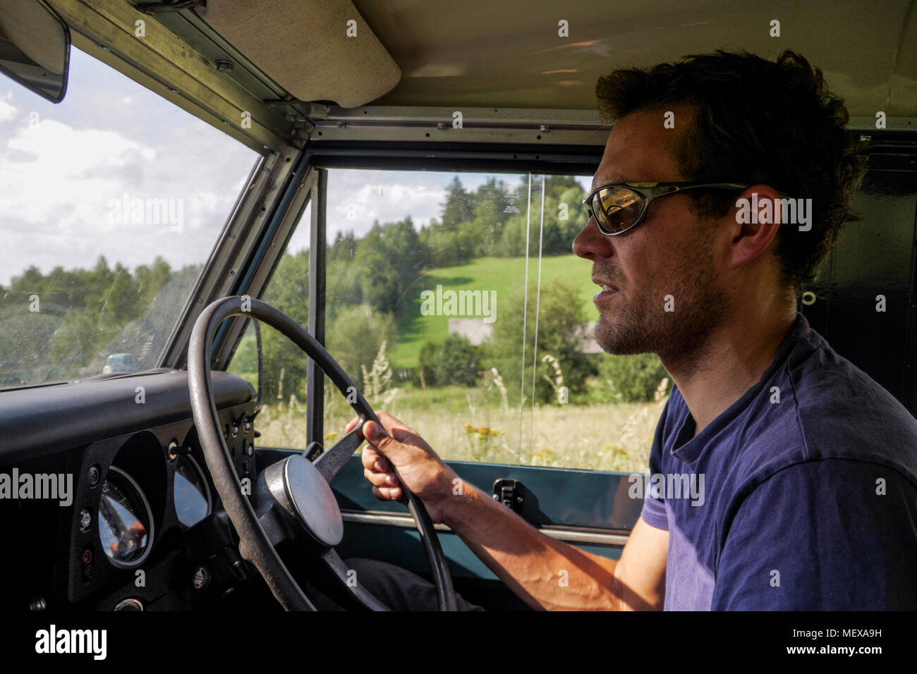 caucasian man driving a off road jeep Stock Photo - Alamy