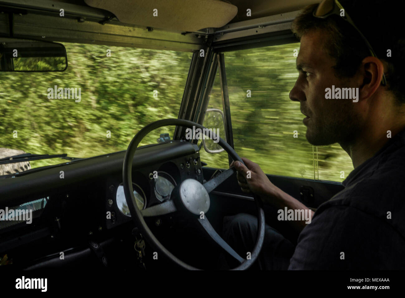 caucasian man driving a off road jeep Stock Photo - Alamy