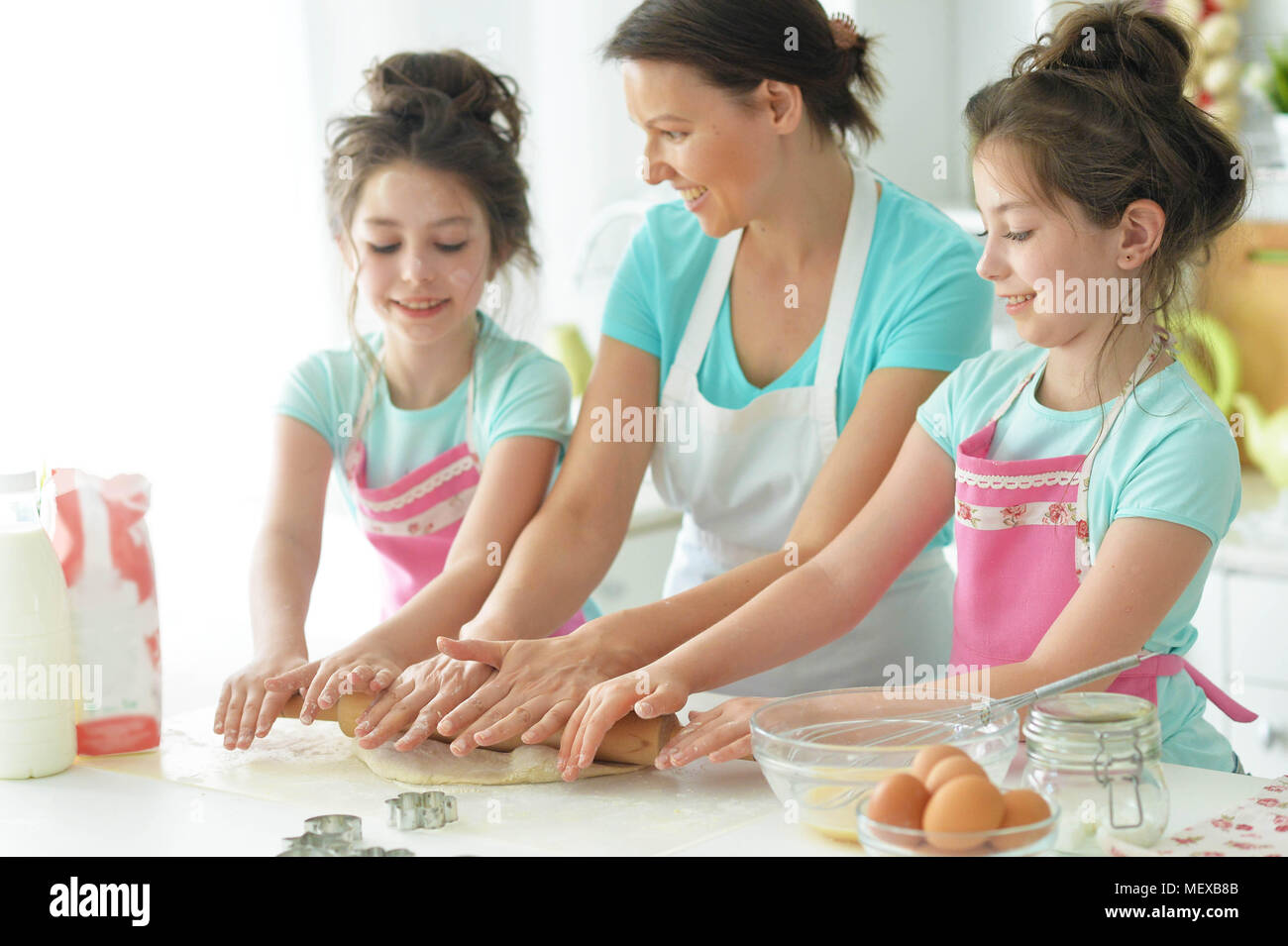 Mom and daughters cook Stock Photo - Alamy