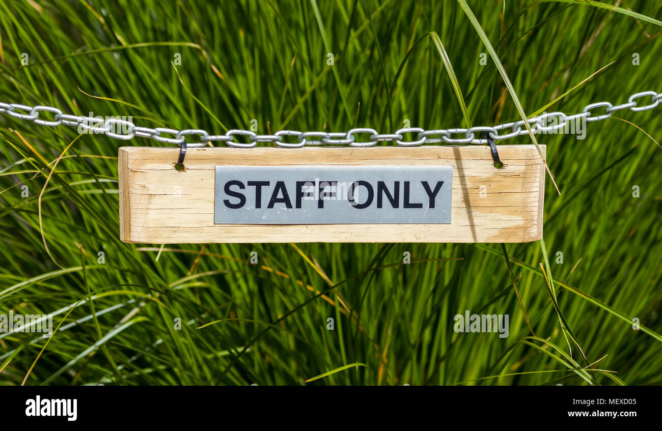 Staff only sing hanging on a chian Stock Photo - Alamy