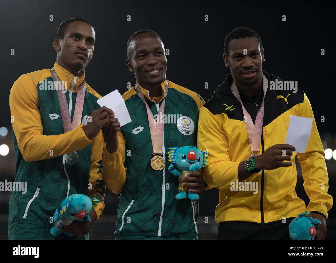 Gold medallist South Africa's Akani Simbine poses with silver medallist ...