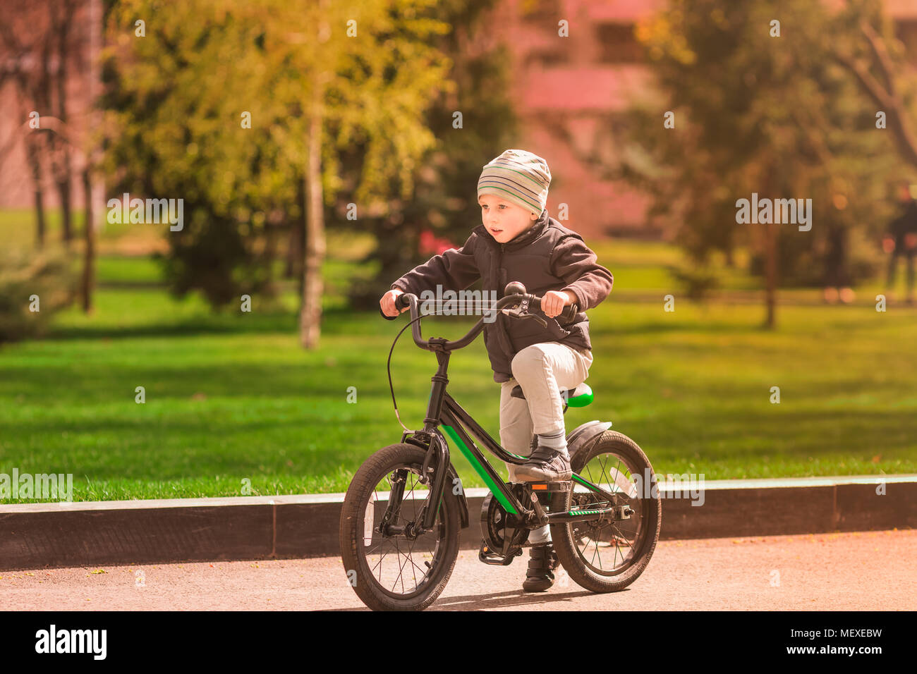 Happy four years old boy learning how to ride a bike. First riding ...
