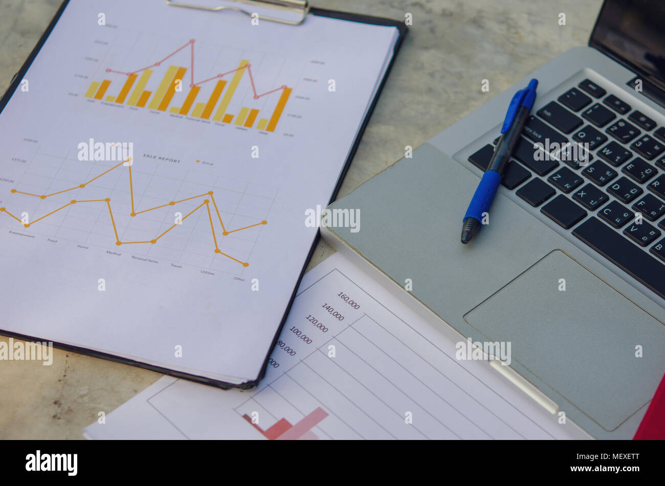 business Financial paper charts and laptop Stock Photo - Alamy