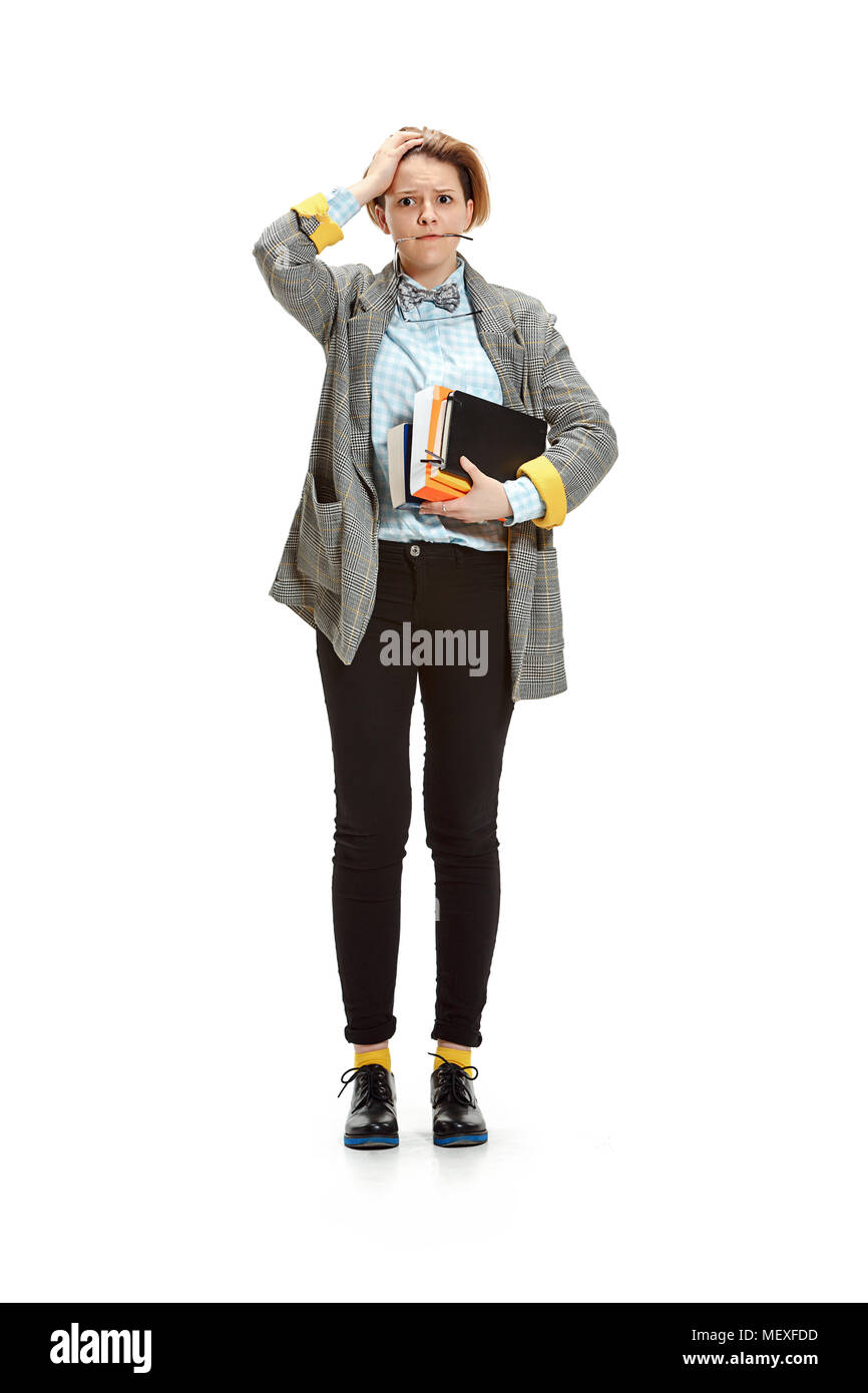 Full length portrait of a sad female student holding books isolated on ...