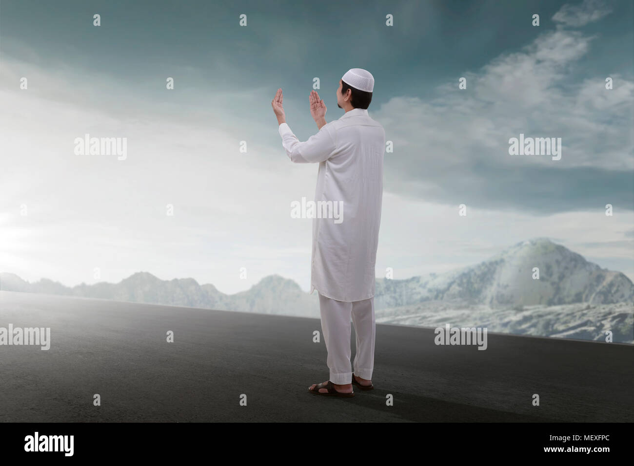 Rear view of asian muslim man praying outdoor Stock Photo - Alamy
