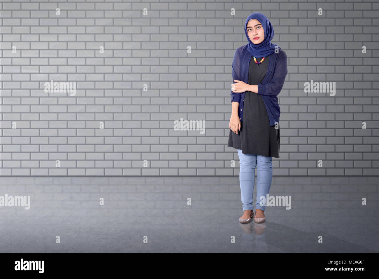 Pretty asian muslim woman standing with confident inside the room Stock ...