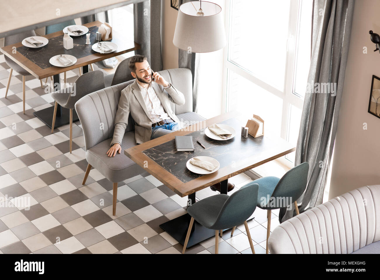 Cheerful relaxed man at business lunch Stock Photo - Alamy