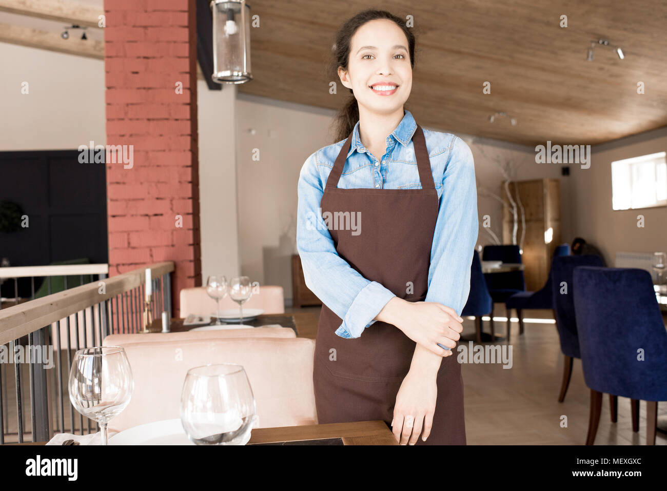 Happy friendly pretty waitress in restaurant Stock Photo - Alamy