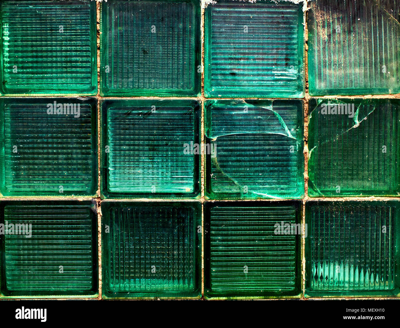 Old, damaged green wall made of square green glass pieces background ...