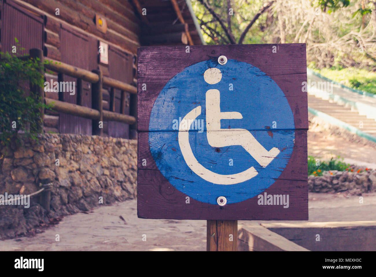 Photograph of a wood handicapped sign at forest Stock Photo - Alamy