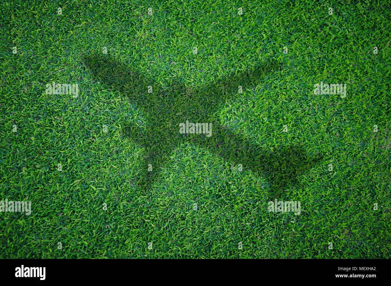 Airplane shadow on green field Stock Photo - Alamy