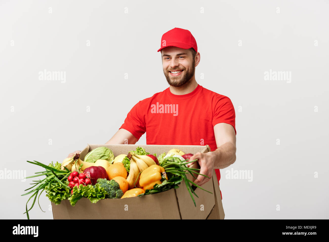 Delivery Concept: Handsome Caucasian grocery delivery courier man in ...