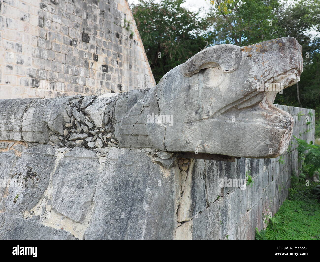 Sculpted stony snake head at mayan ruins of great ball court building ...