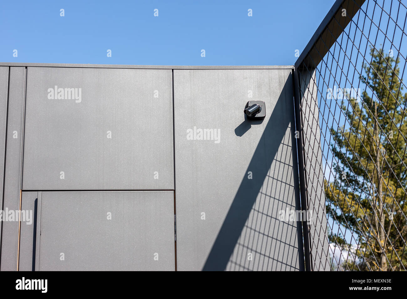 cctv security system camera on black metal wall Stock Photo - Alamy