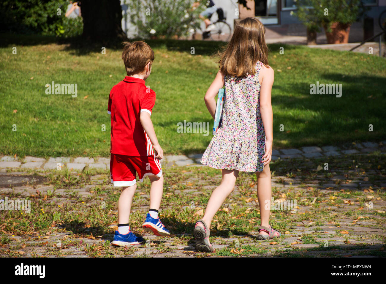 German brother and sister walking cross garden go to father and mother ...