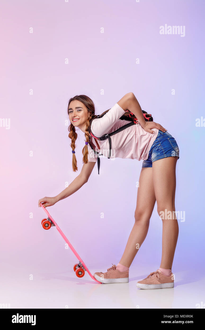beautiful woman with skate in studio Stock Photo - Alamy
