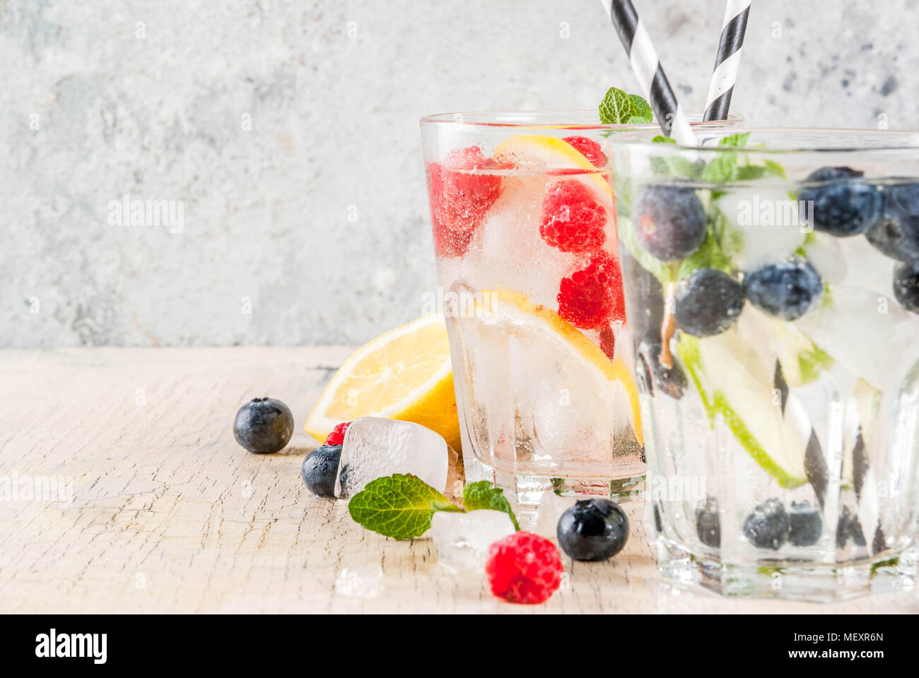 Various berry lemonade or mojito cocktails, fresh iced lemon lime ...