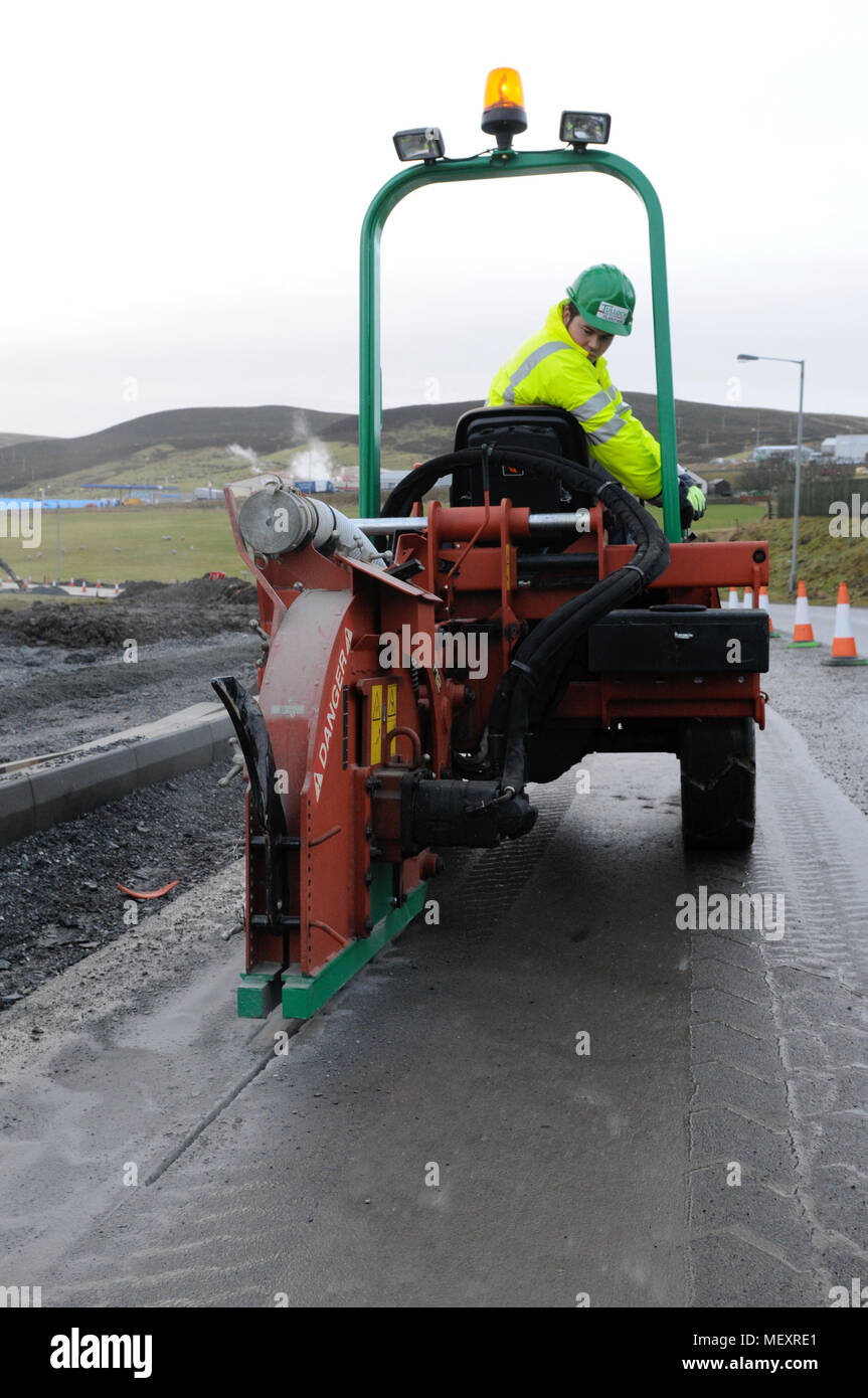 Track being cut in road by a saw so broadband cable can be laid Stock ...