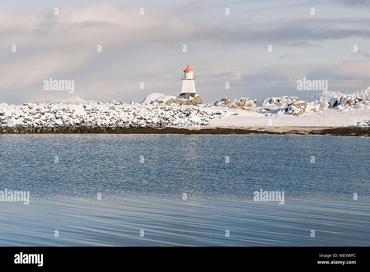 isolated lighthouse in the winter icy landscape of the lofoten islands ...