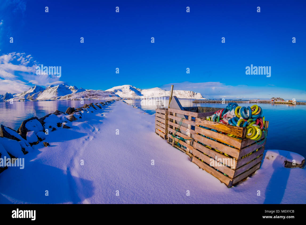 Outdoor scenic view with rocks covered with snow close to a lake and ...