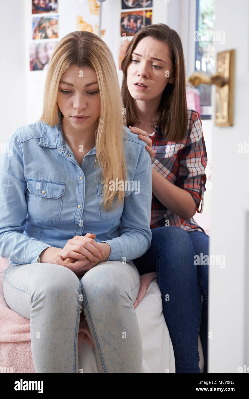 Teenage Girl Comforting Unhappy Friend In Bedroom Stock Photo - Alamy