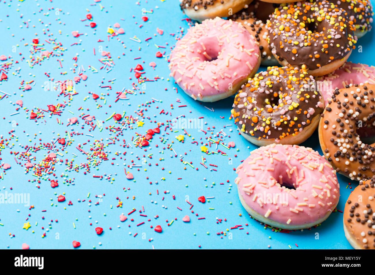 Colorful round donuts on blue background. Flat lay, top view Stock ...