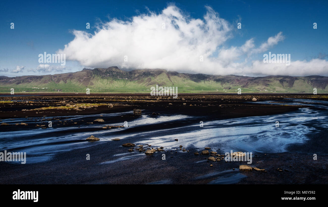 Black sand beach in iceland tide contrasty white cloud Stock Photo - Alamy