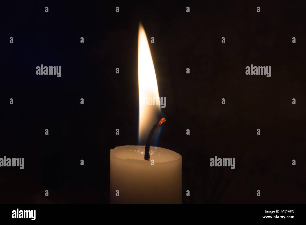 Candlelight illuminating a dark room in the evening Stock Photo - Alamy