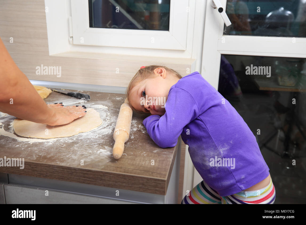 Girl in kitchen tired cooking with mother. Family background Stock ...