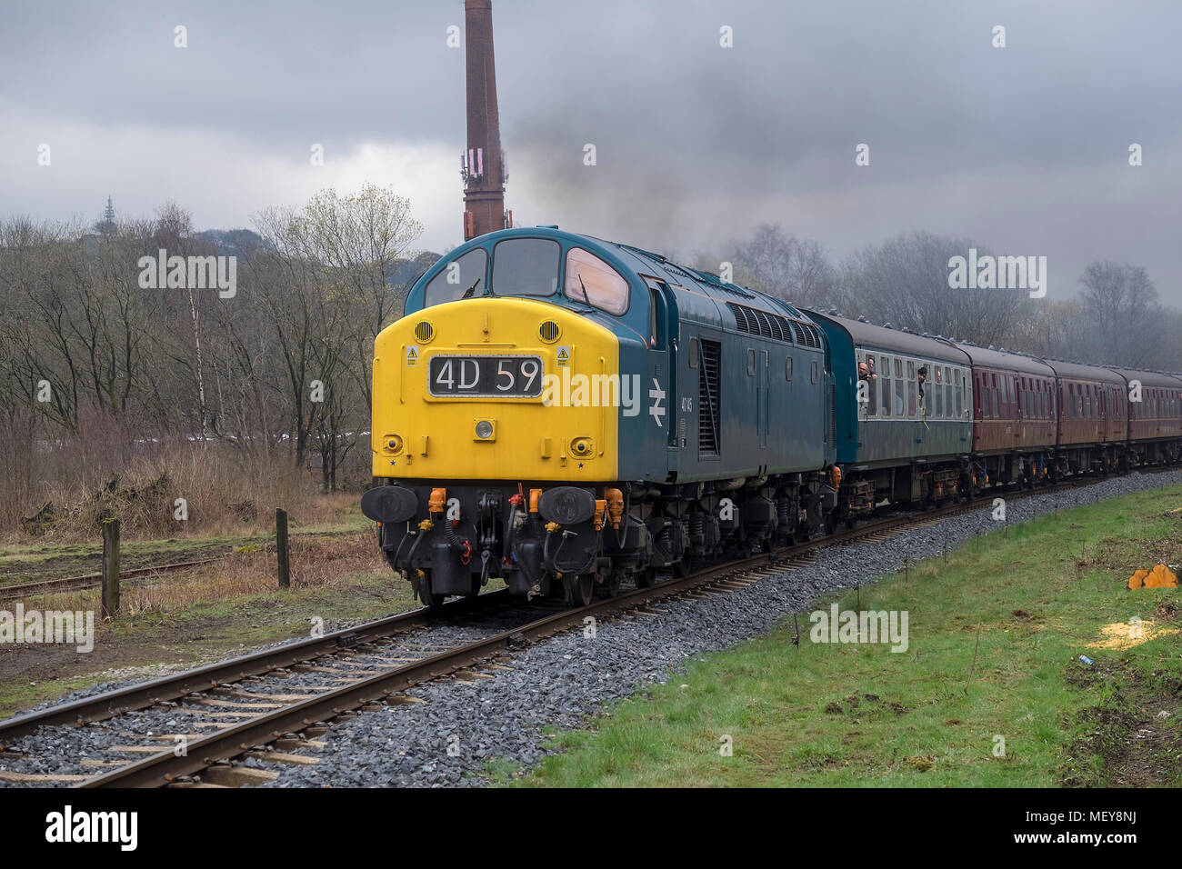 Diesel engine pulls passenger train Stock Photo - Alamy