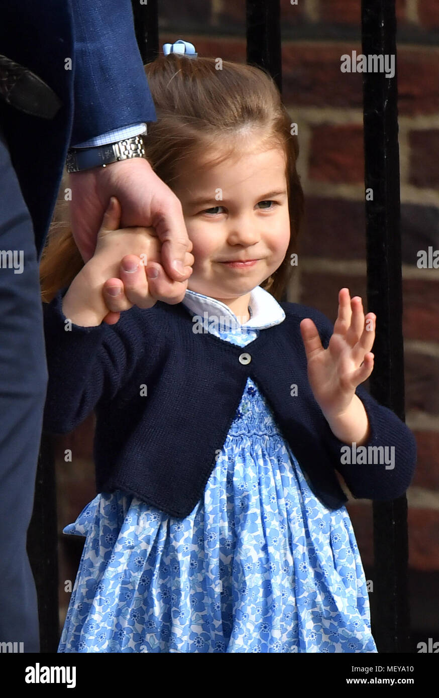 Princess Charlotte holds her fathers hand as she arrives to meet her ...