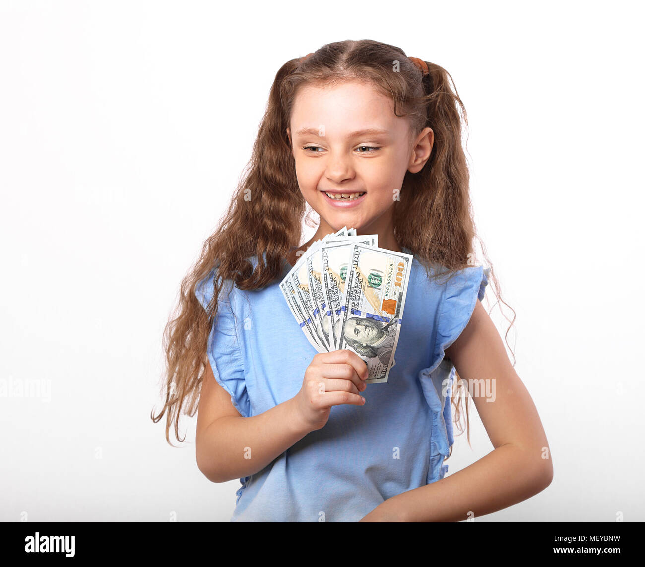 Happy smiling rich kid girl holding money in the hand with natural ...