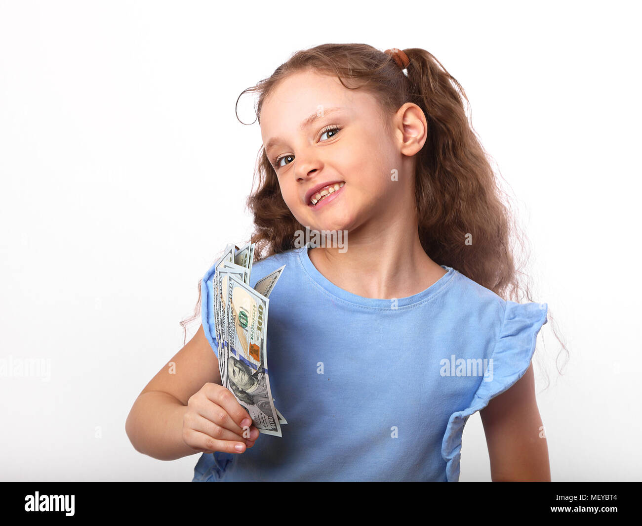 Happy laughing rich kid girl holding money hand on white background ...