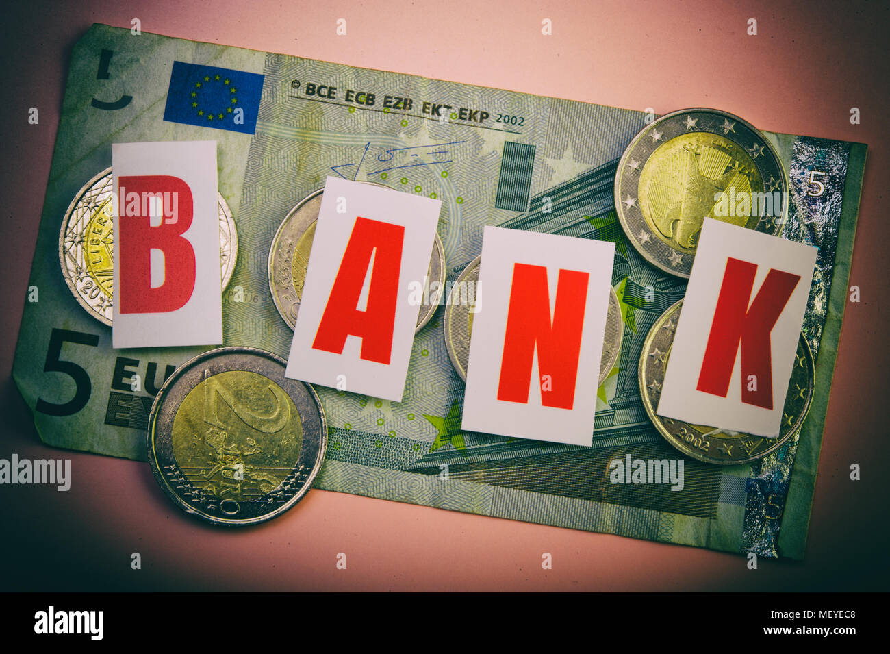 inscription bank on the background of coins of euro cents and an old ...
